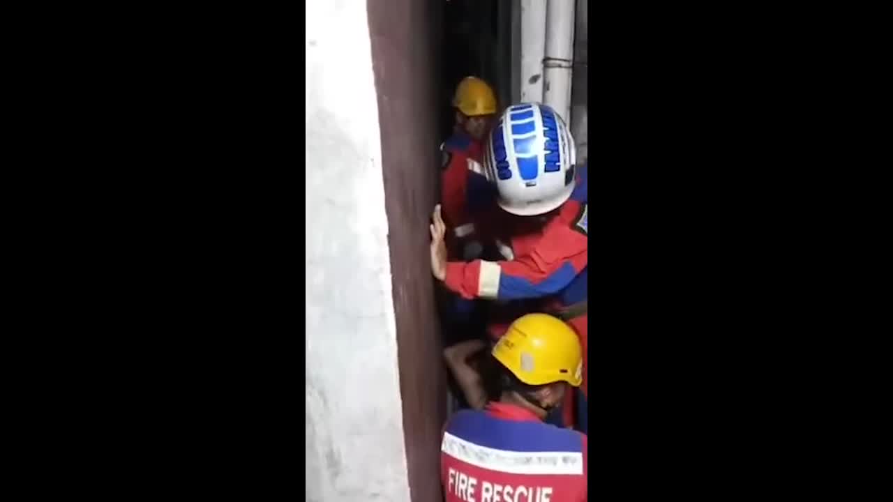 Rescue team saves elderly woman trapped in narrow gap between houses