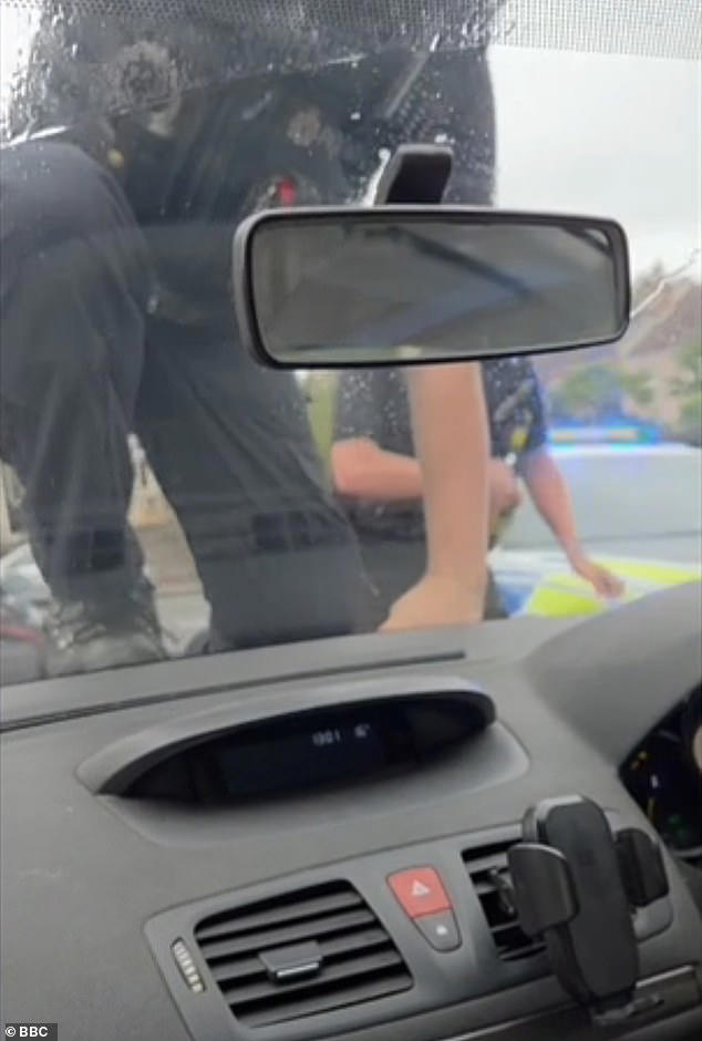 Shocking moment police clamber over car and Taser driver after 27 ...