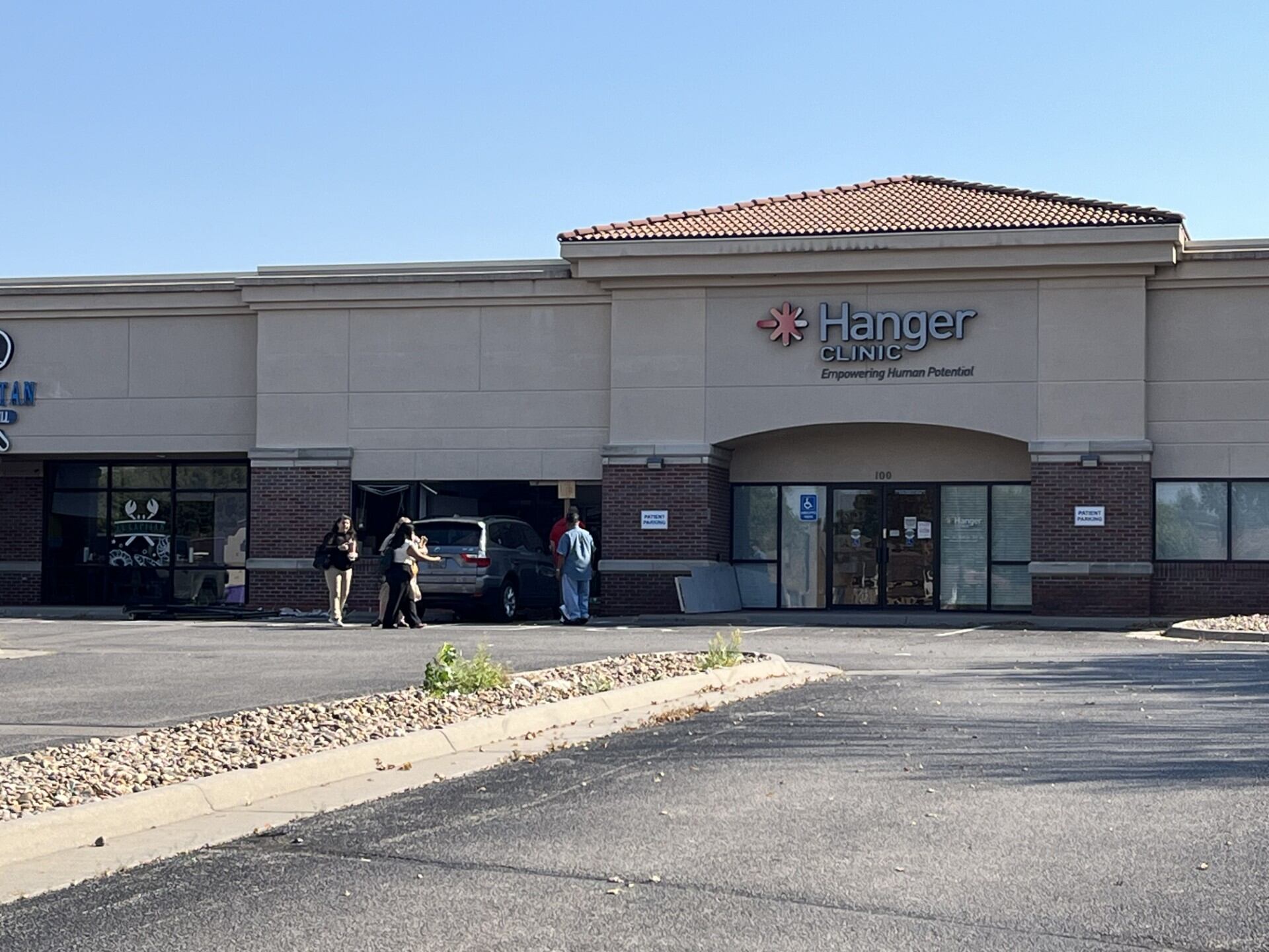 Two hurt after car drives into building in east Wichita