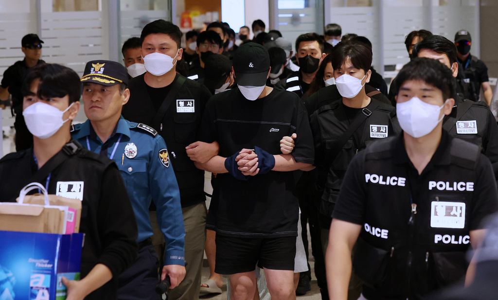 Koreans linked to alleged online scams in Cambodia arrive home to face ...