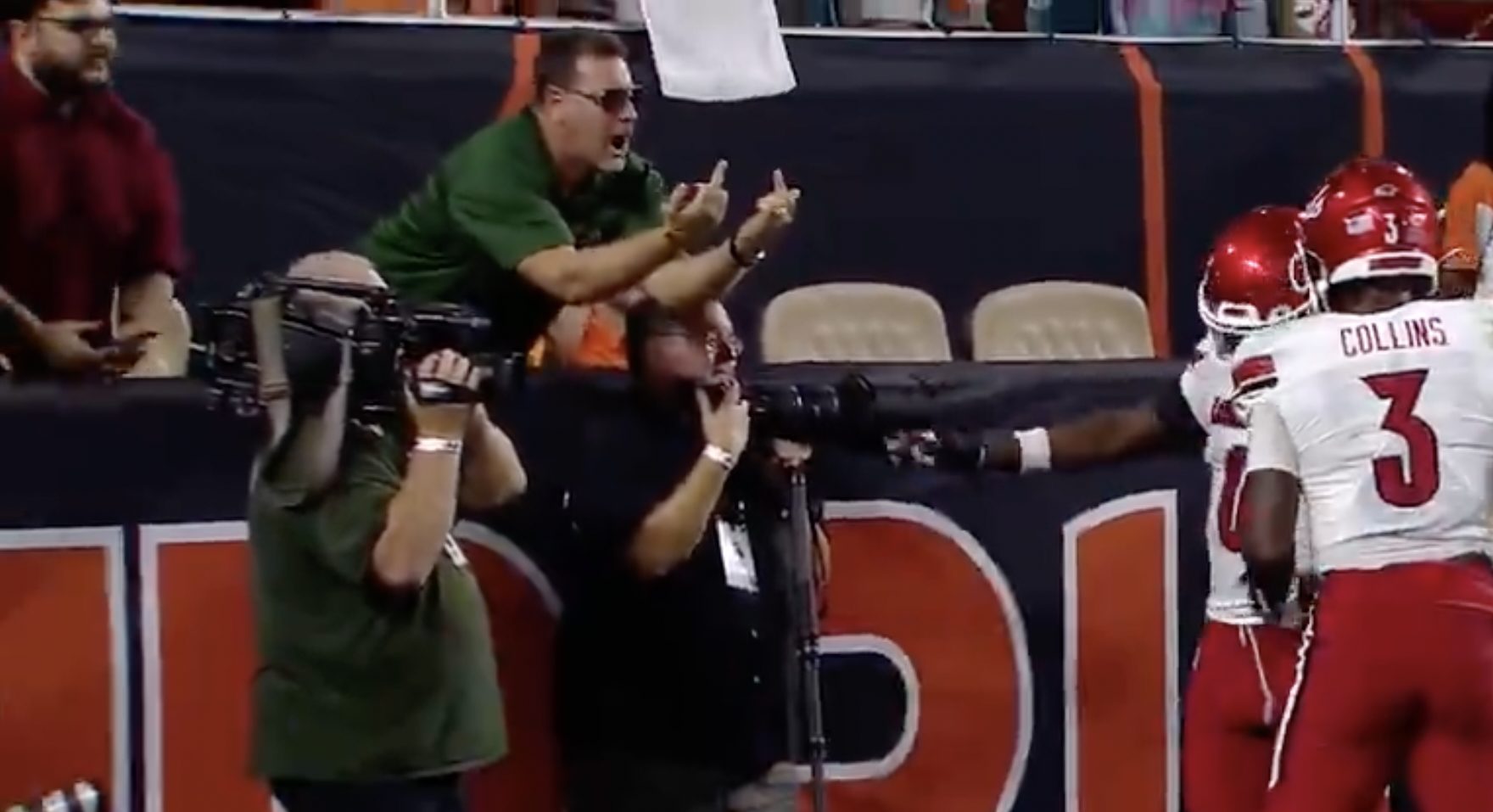 Fan flips double bird at college football player