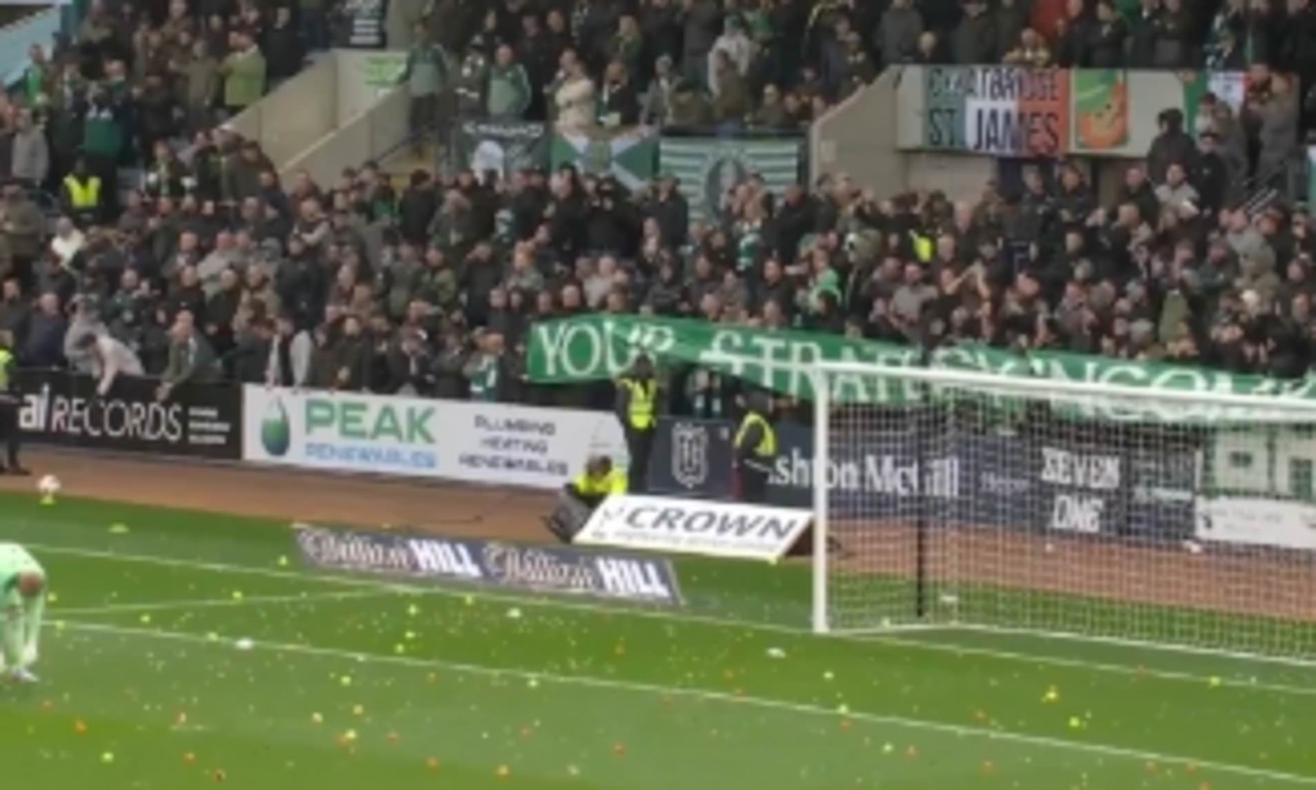 Raging Celtic fans hurl tennis balls and oranges onto the pitch with ...