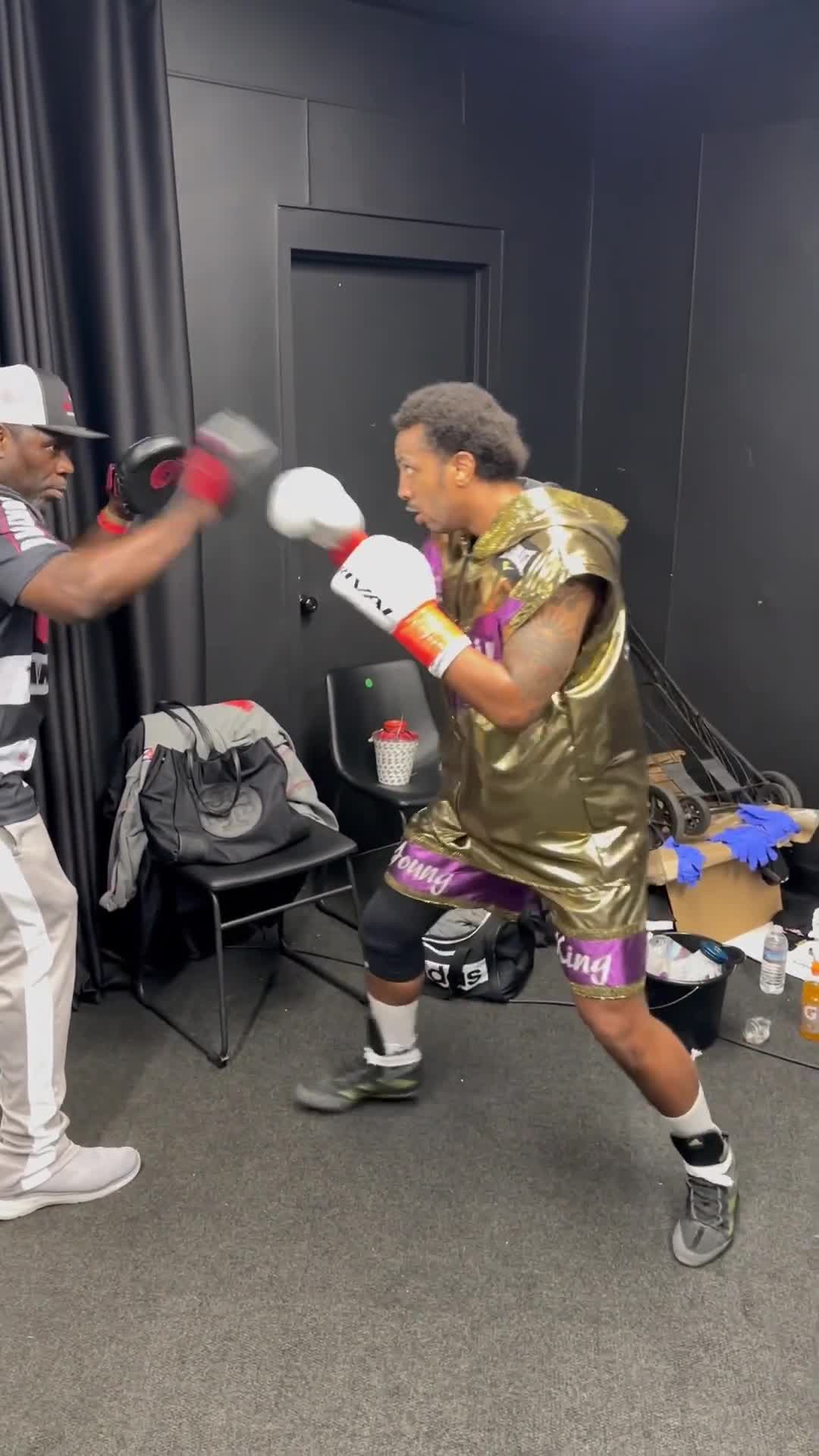 Christopher Pearson warming up with Nate Jones on pads