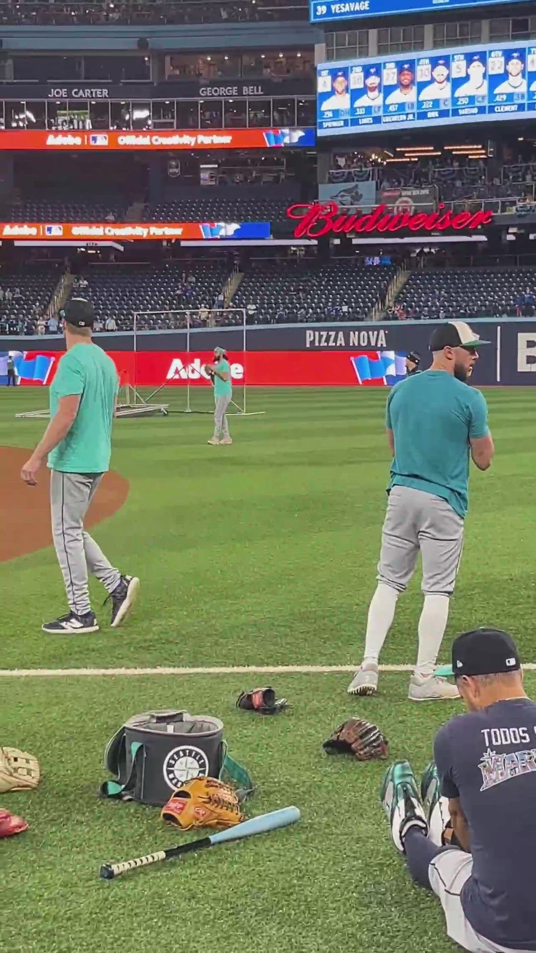 Mariners players warm up their arms for ALCS Game 6 with a football
