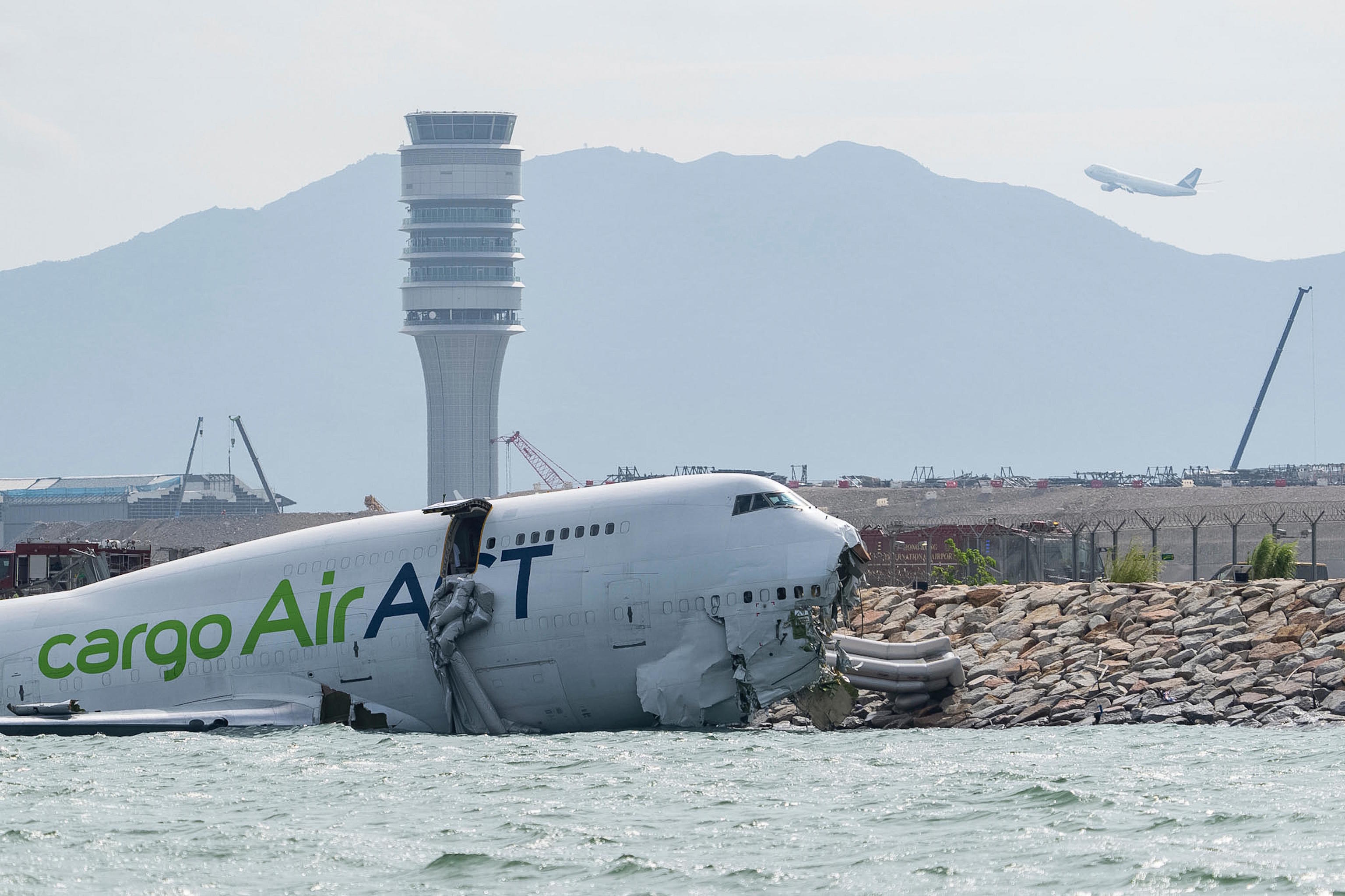 Two dead after plane skids off runway, crashes into car, and falls into ...