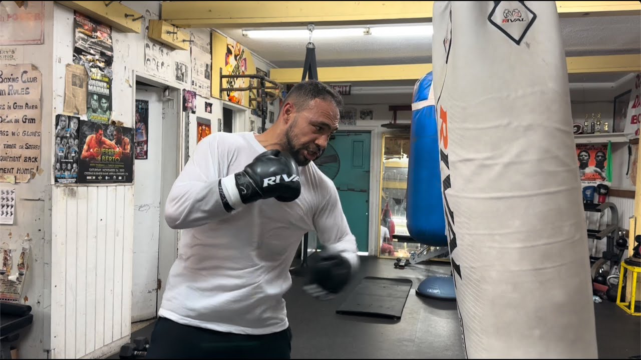 KEITH THURMAN DISPLAYS AN ARRAY OF PUNCHES ON THE HEAVY BAG DURING CAMP ...