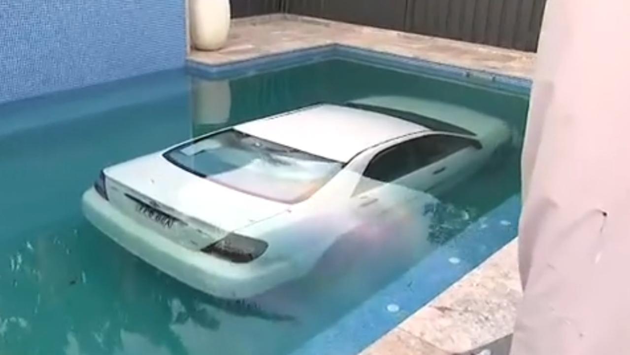 Wild moment car crashes into backyard pool