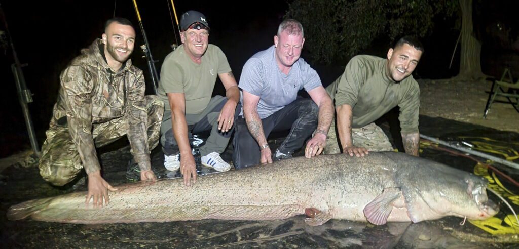 British tourists reel in record 258lb catfish in gruelling 30-minute battle