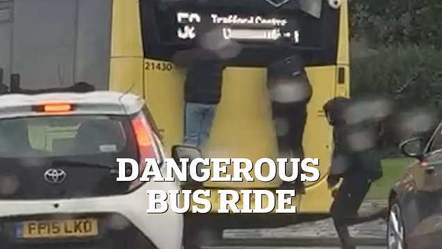 Shocking moment teens spotted clinging to back of a moving bus