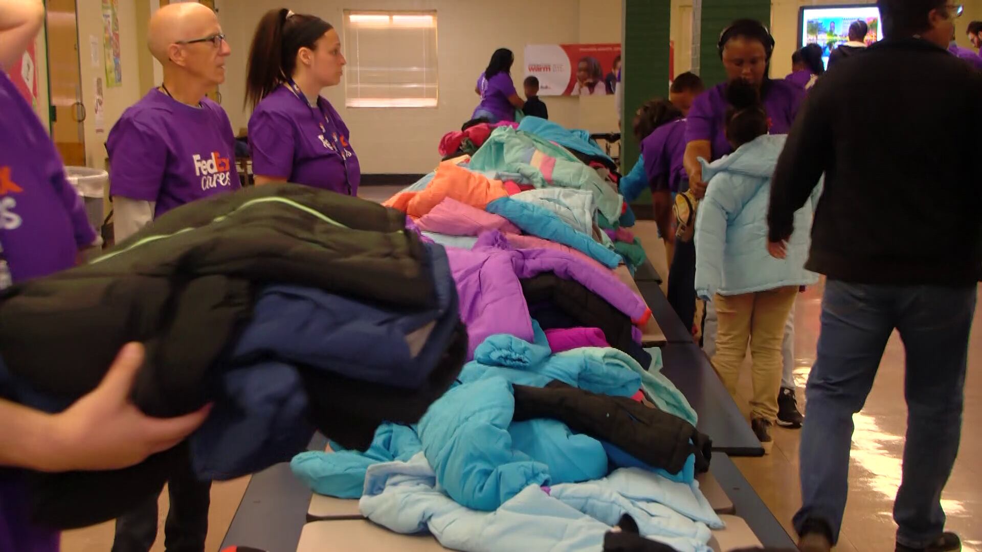 FedEx volunteers deliver winter coats to Frayser Elementary students