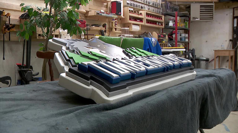 Woodworker makes retro Timberwolves sign to celebrate new season