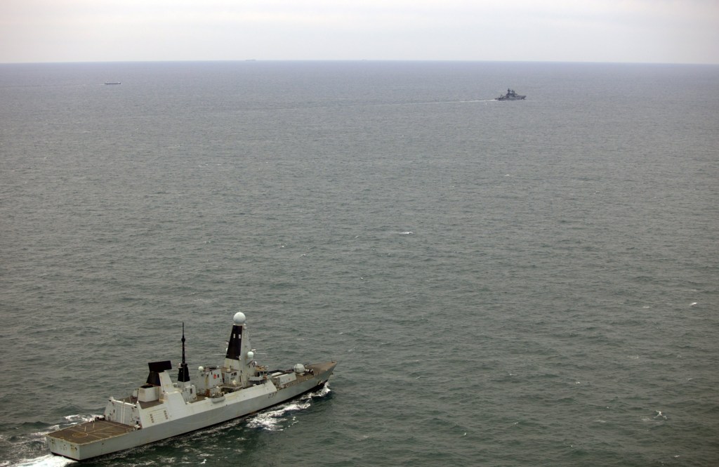Navy destroyer and helicopter shadow Russian warship in UK waters