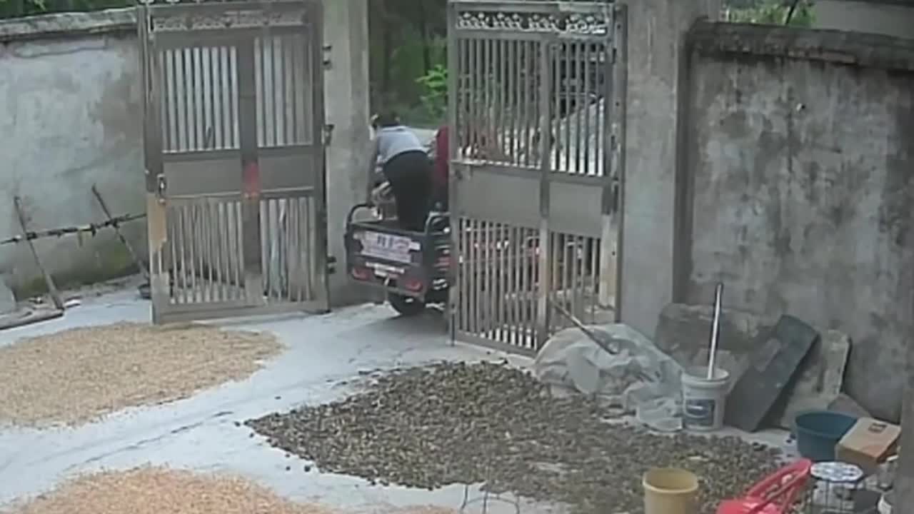 Girl falls to her knees after closing gate while standing on tricycle