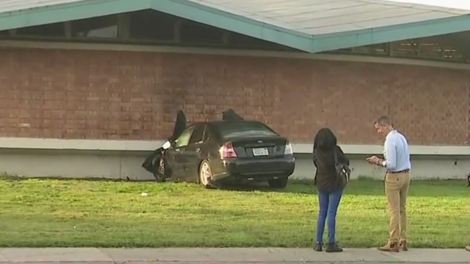 2 people hospitalized after crashing car into middle school building