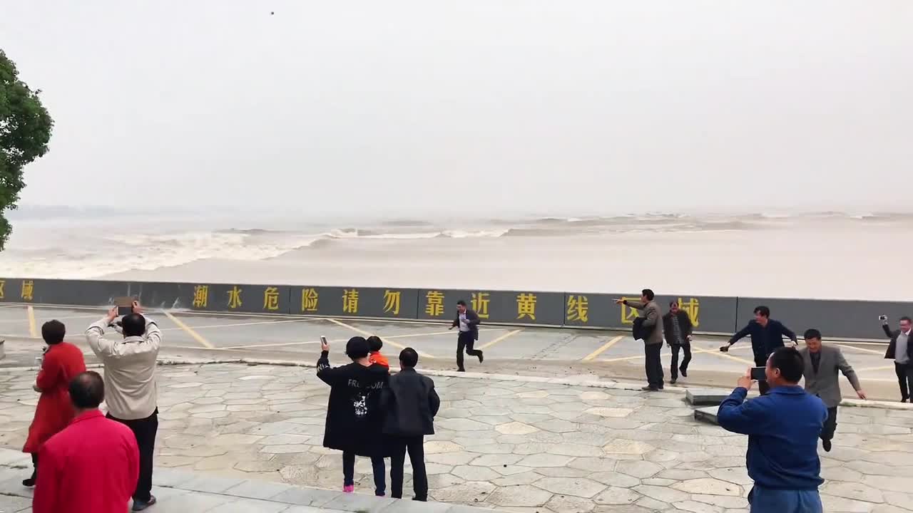 High tide waves splashing over Qiantang River embankment in Zhejiang, China