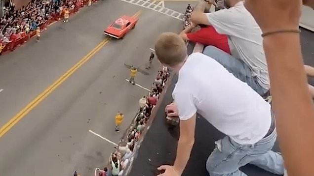 Daredevil stunt driver speeds through town fountain