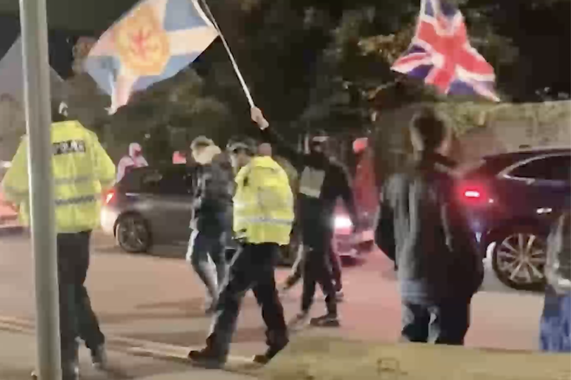 Mob of masked anti-immigration protesters march through Falkirk with ...