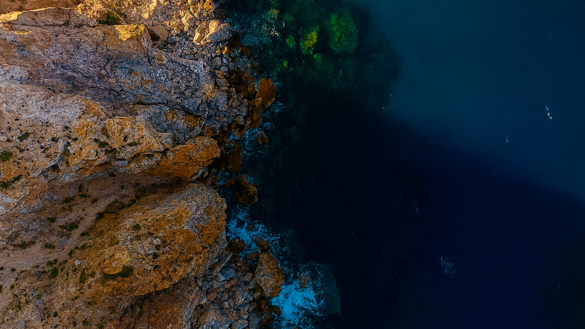 Rocky Cliff and Deep Blue Ocean