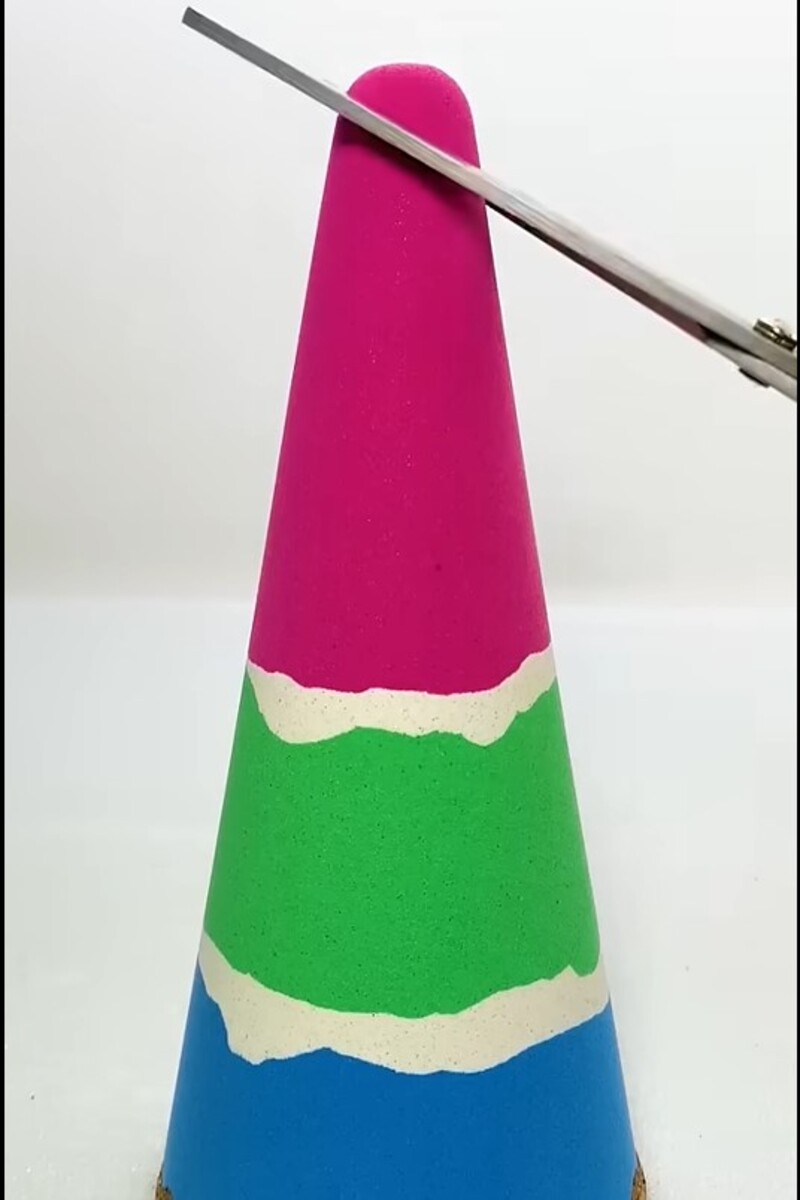 Cutting a Tall Rainbow Sand Cone