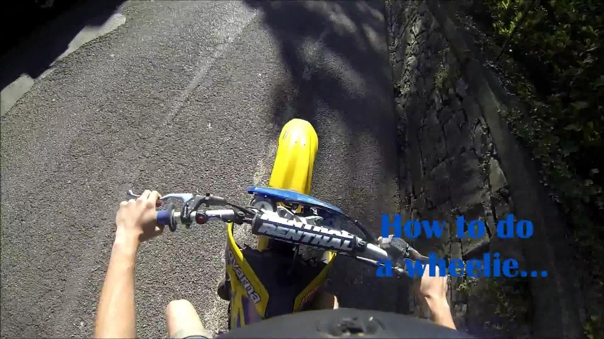 Dirt Biker Attempts Wheelie and Falls Backwards