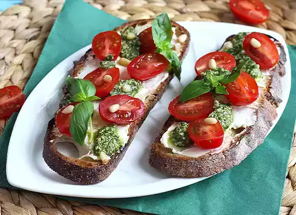 Fresh cheese, pesto, and cherry tomato toasts