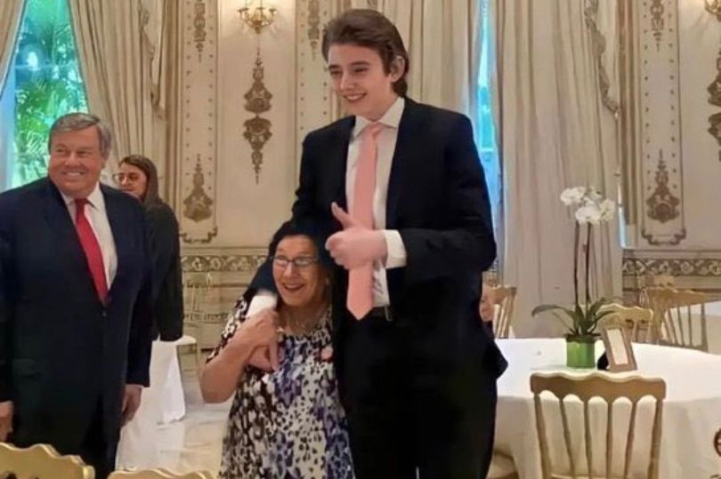 Newly unearthed image shows Barron Trump towering over tiny woman