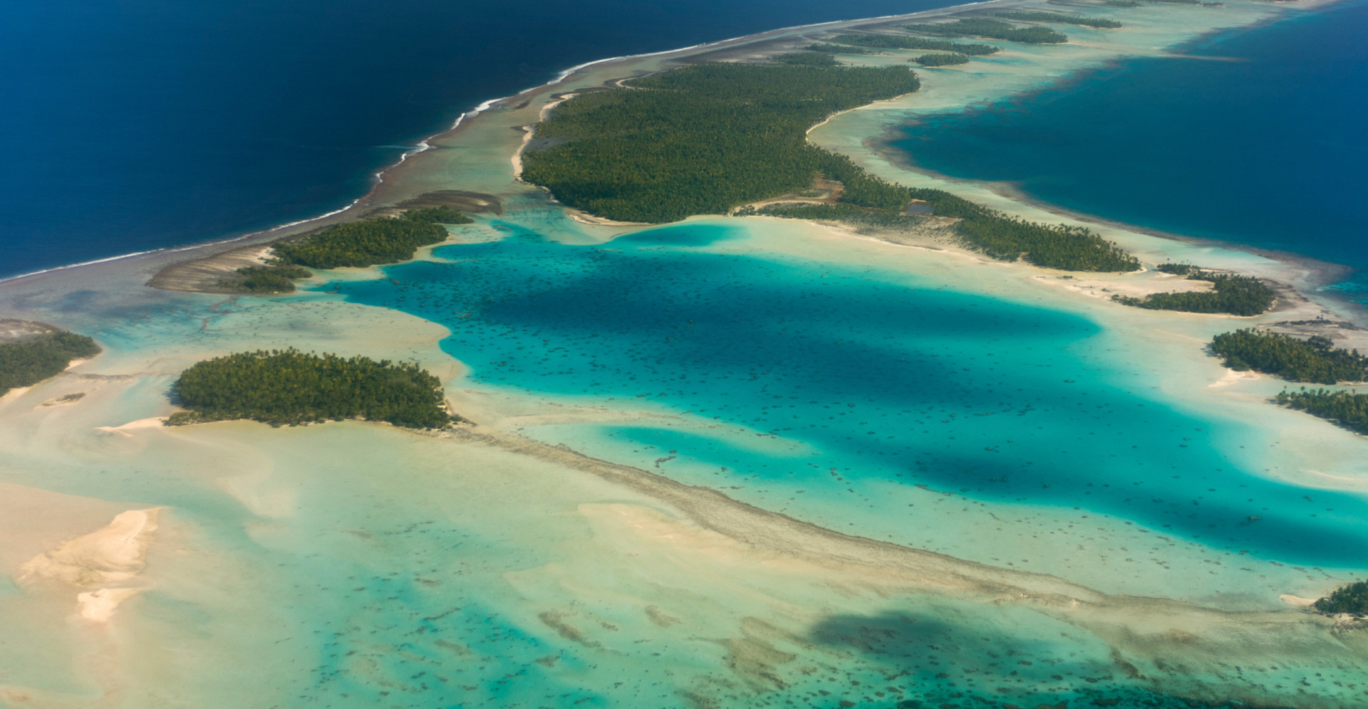 Where to admire coral atolls created by underwater volcanoes