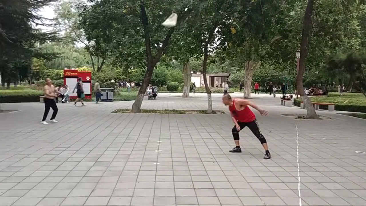 Old men passing sandbags for workout in Hebei, China