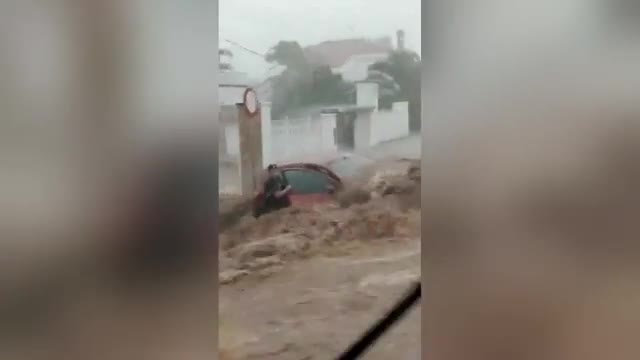 Trapped drivers battle raging torrents of mud water as flash floods rip ...