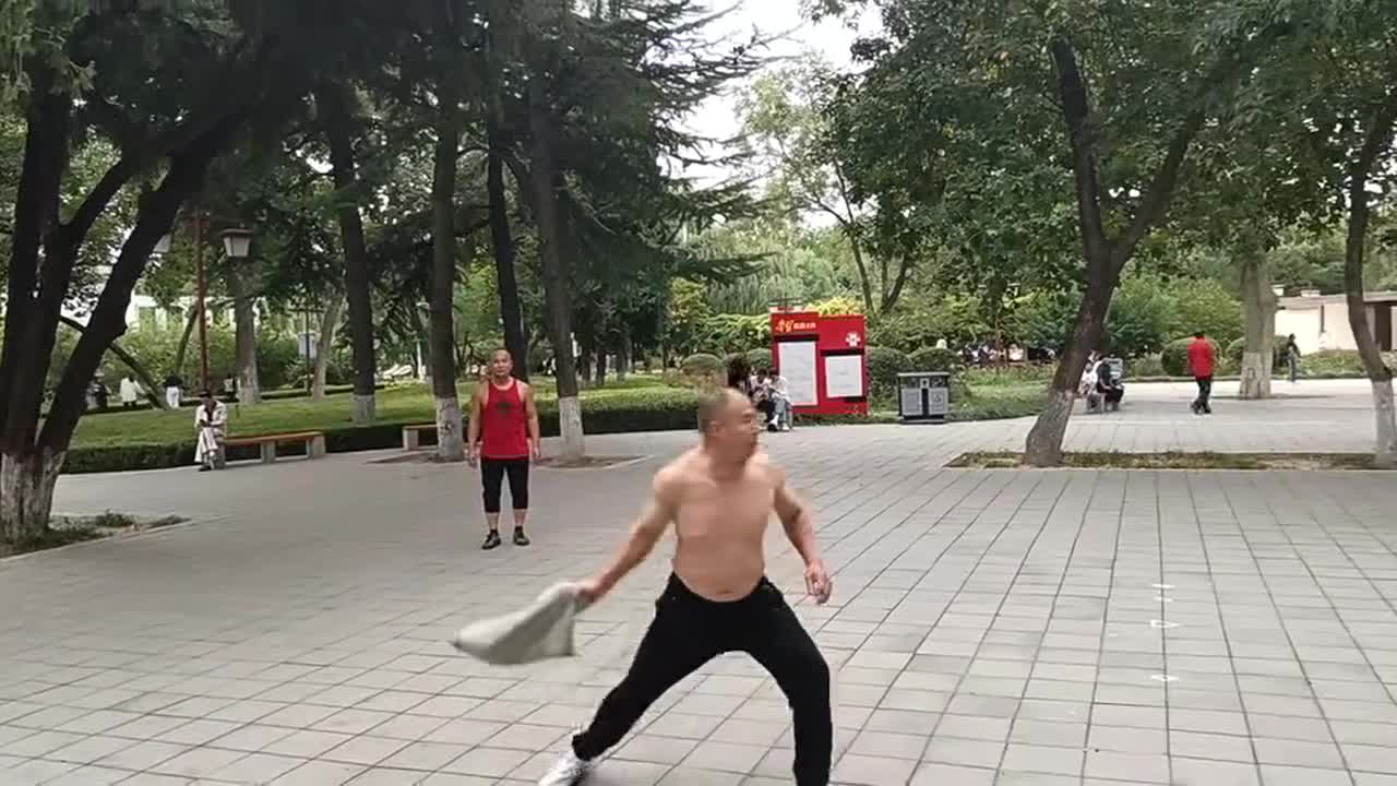 Old men passing sandbags for workout in Hebei, China