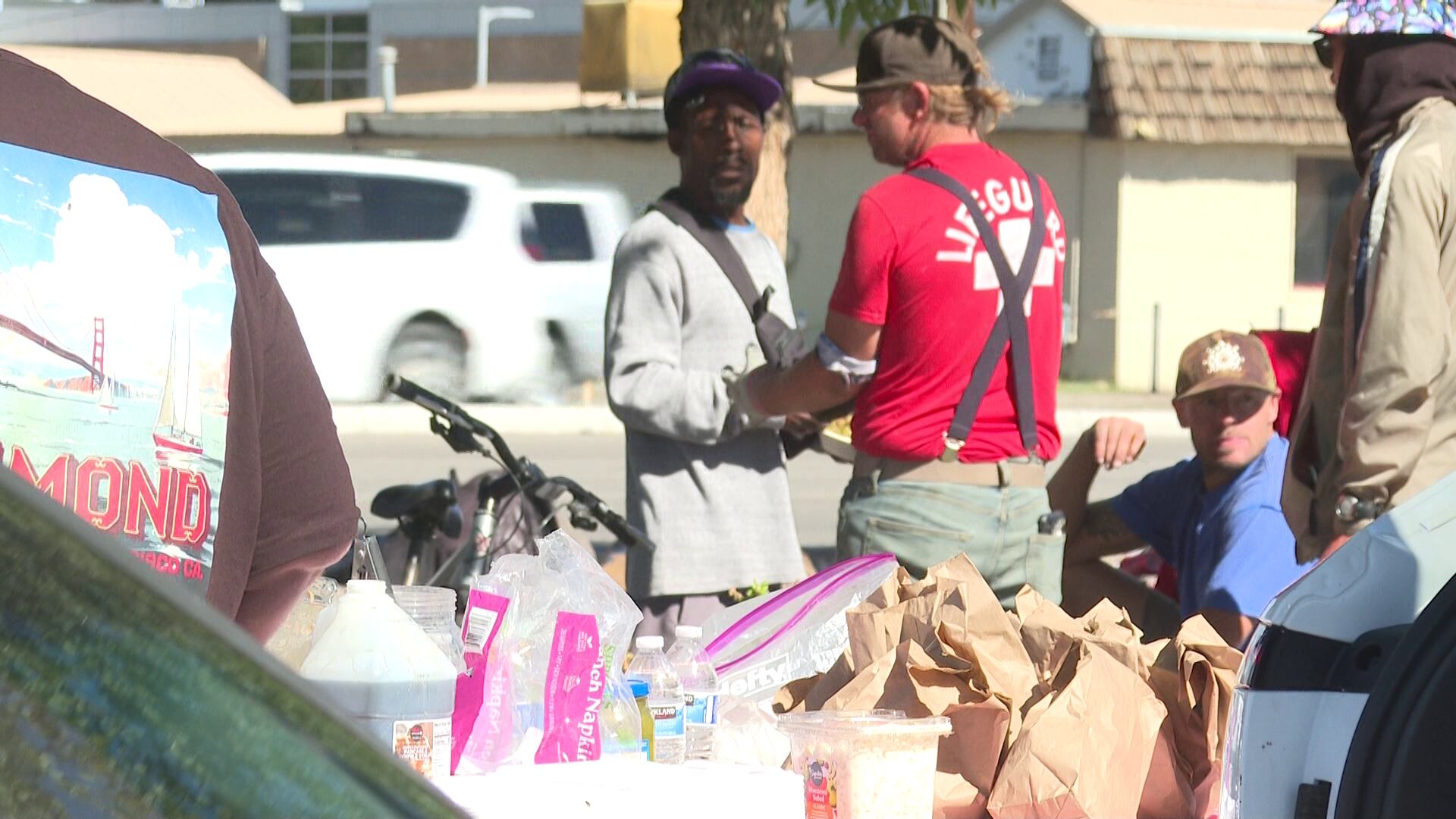 Volunteers feed homeless outside closed Homeward Bound shelter in Grand ...