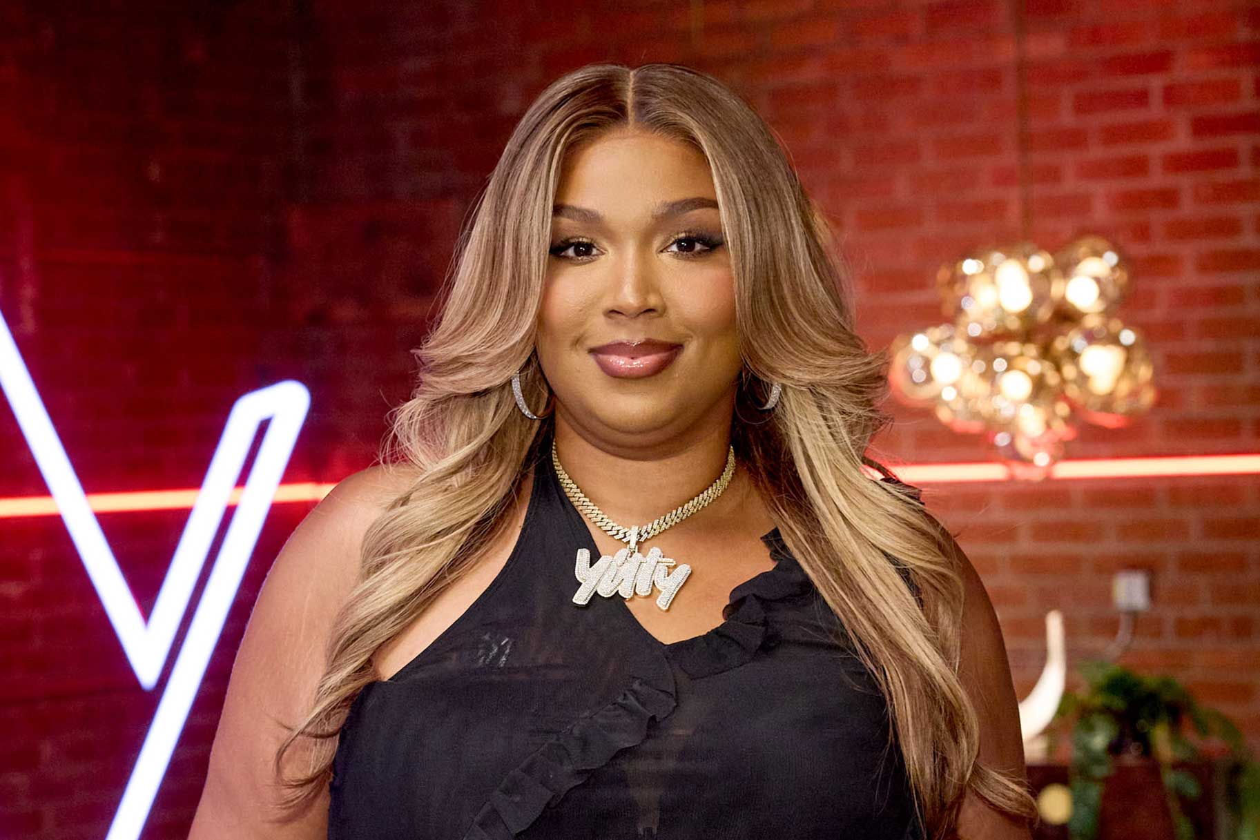 What Does Lizzo’s Necklace on The Voice Say?