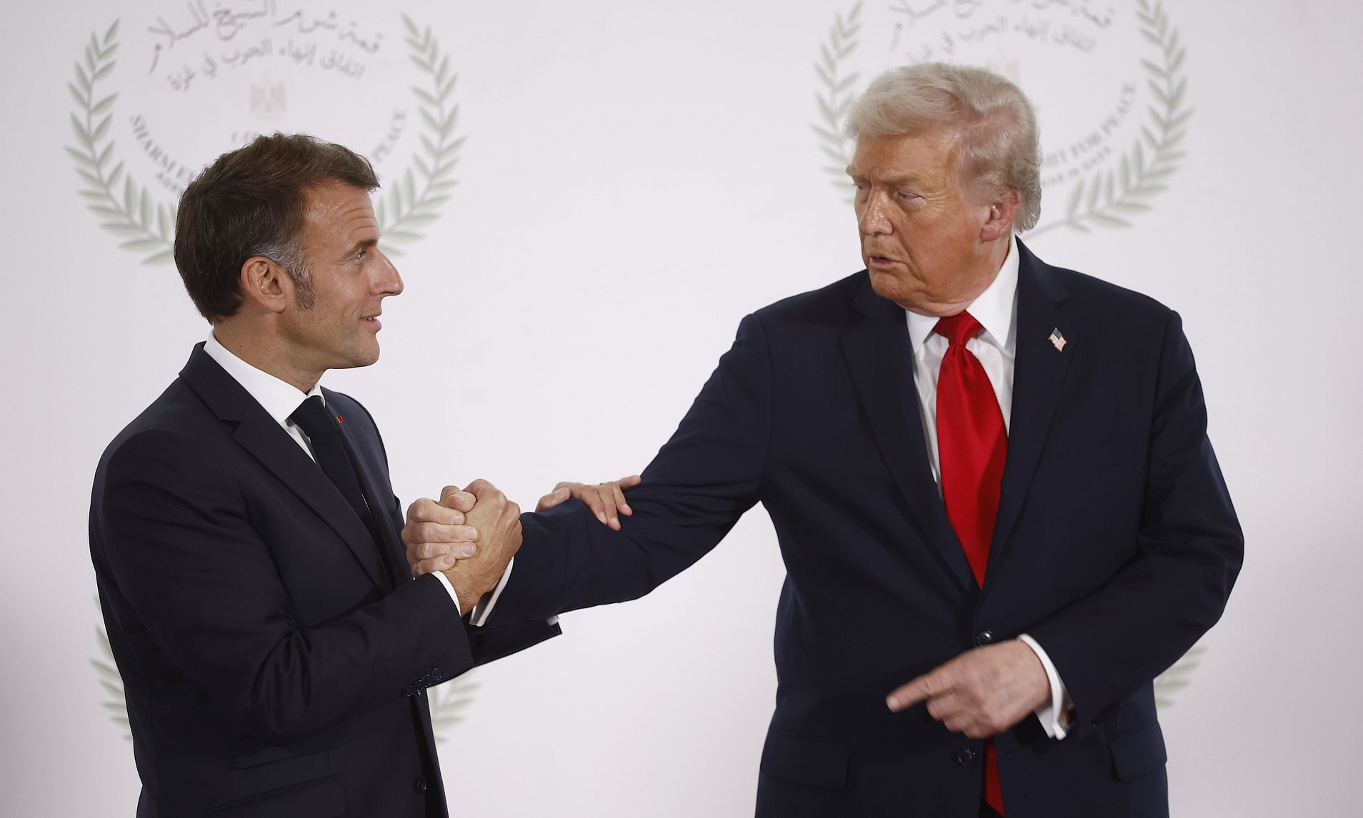 Trump yanks Macron's hand in tense moment in Egypt and asks French PM ...