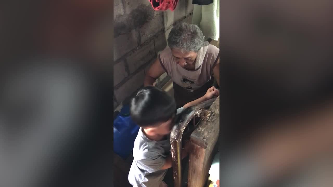 Caring toddler helps frail grandfather climb the stairs