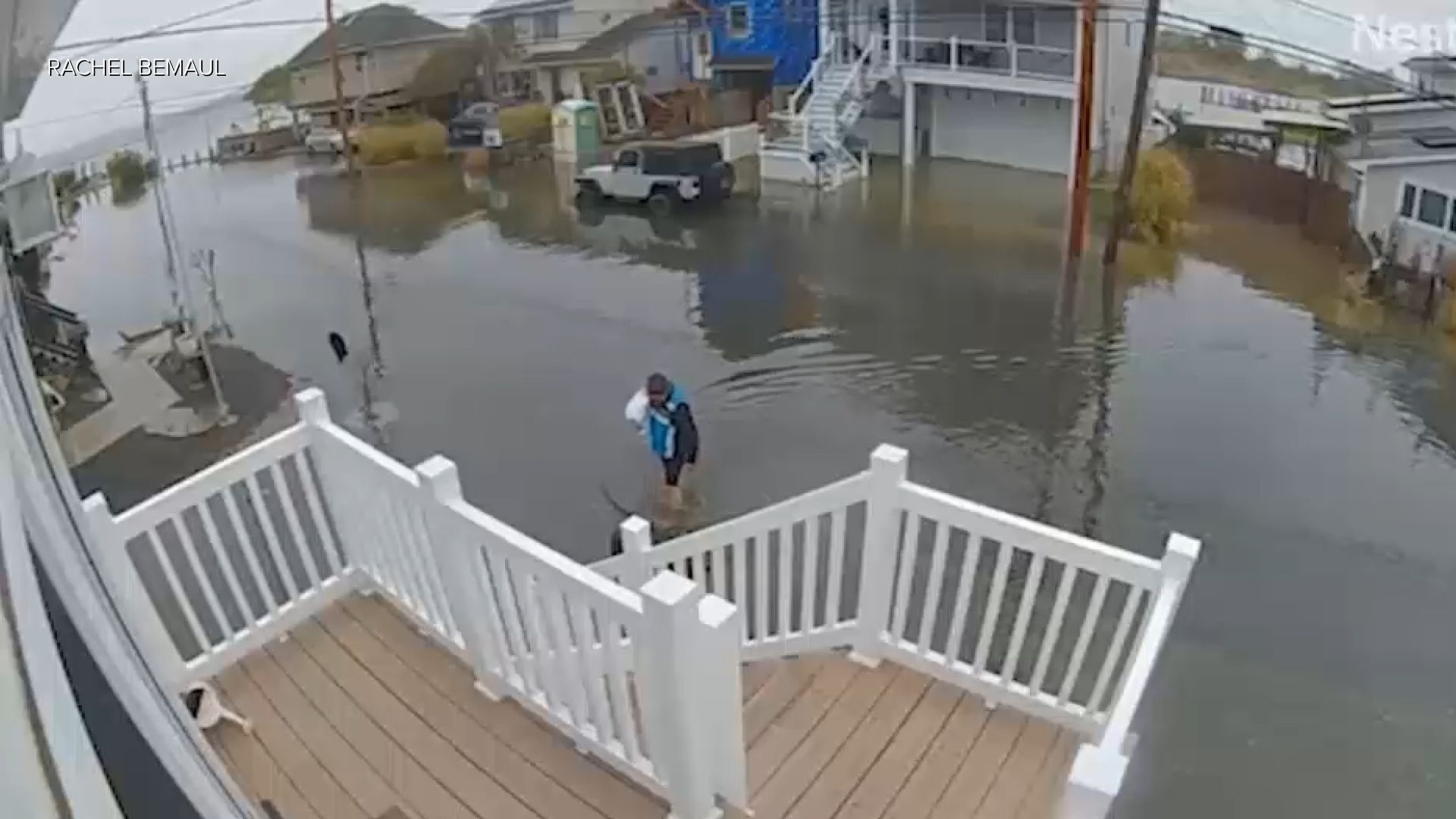 Amazon worker wades barefoot in flood water during severe storm to ...