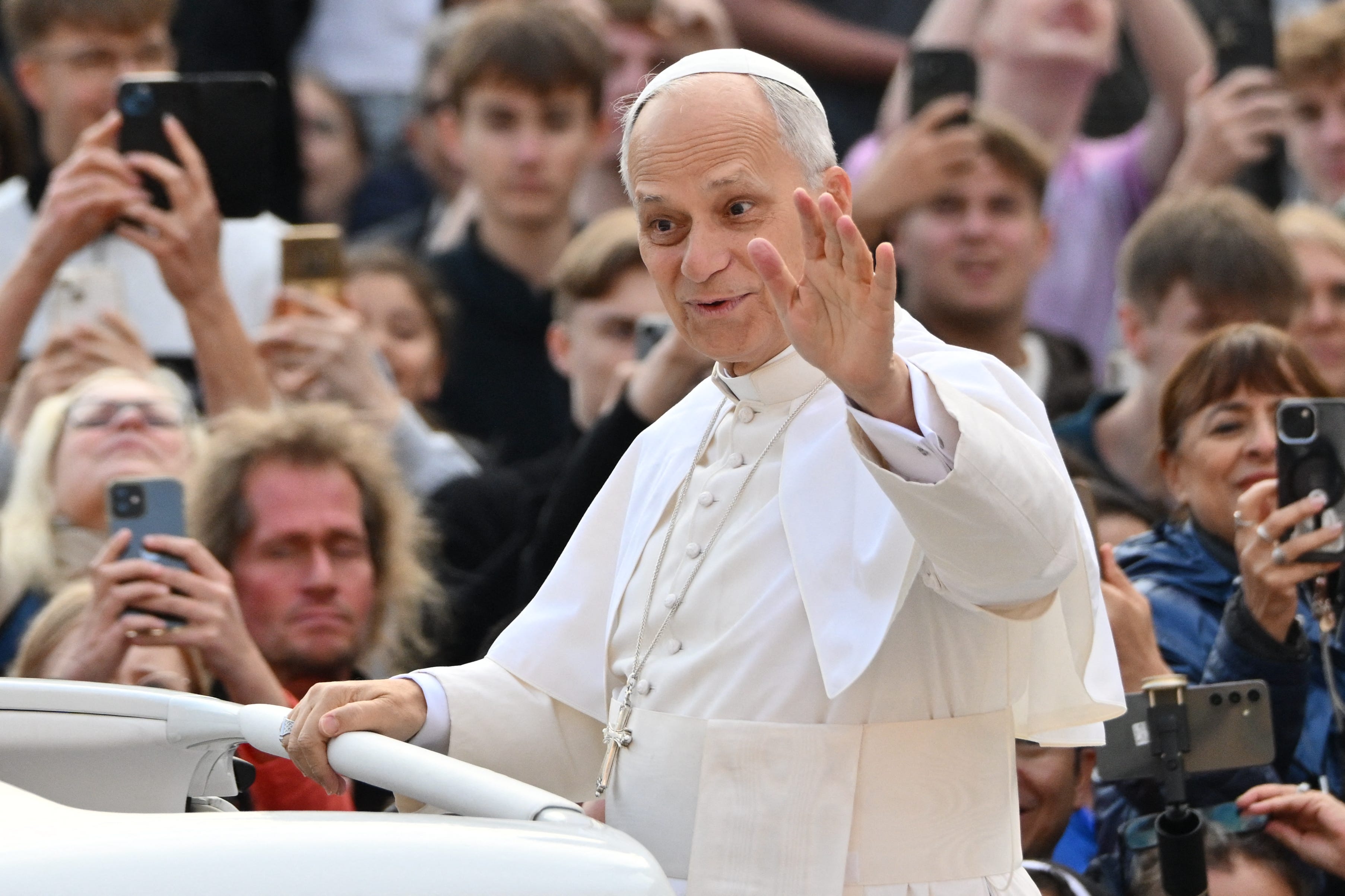 Pope Leo XIV responds to Chicago Cubs fan during a parade in Vatican City