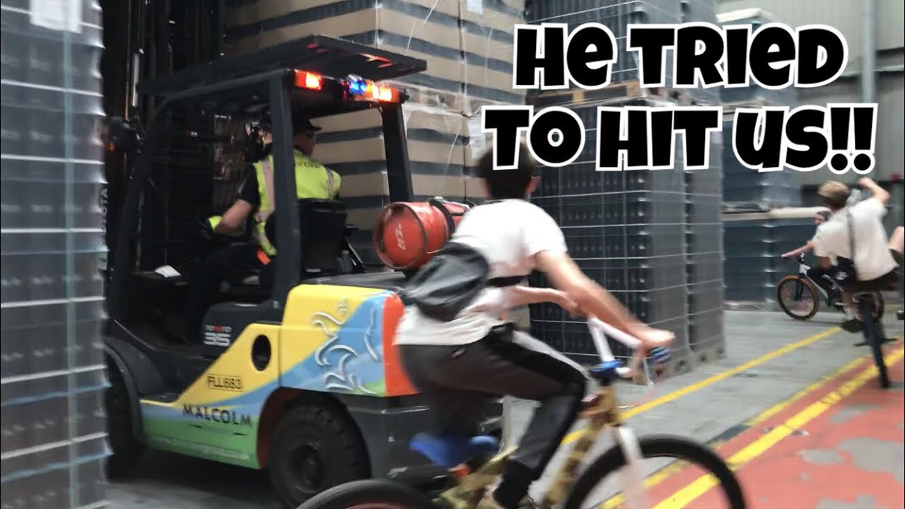 An angry forklift driver chases kids on bikes