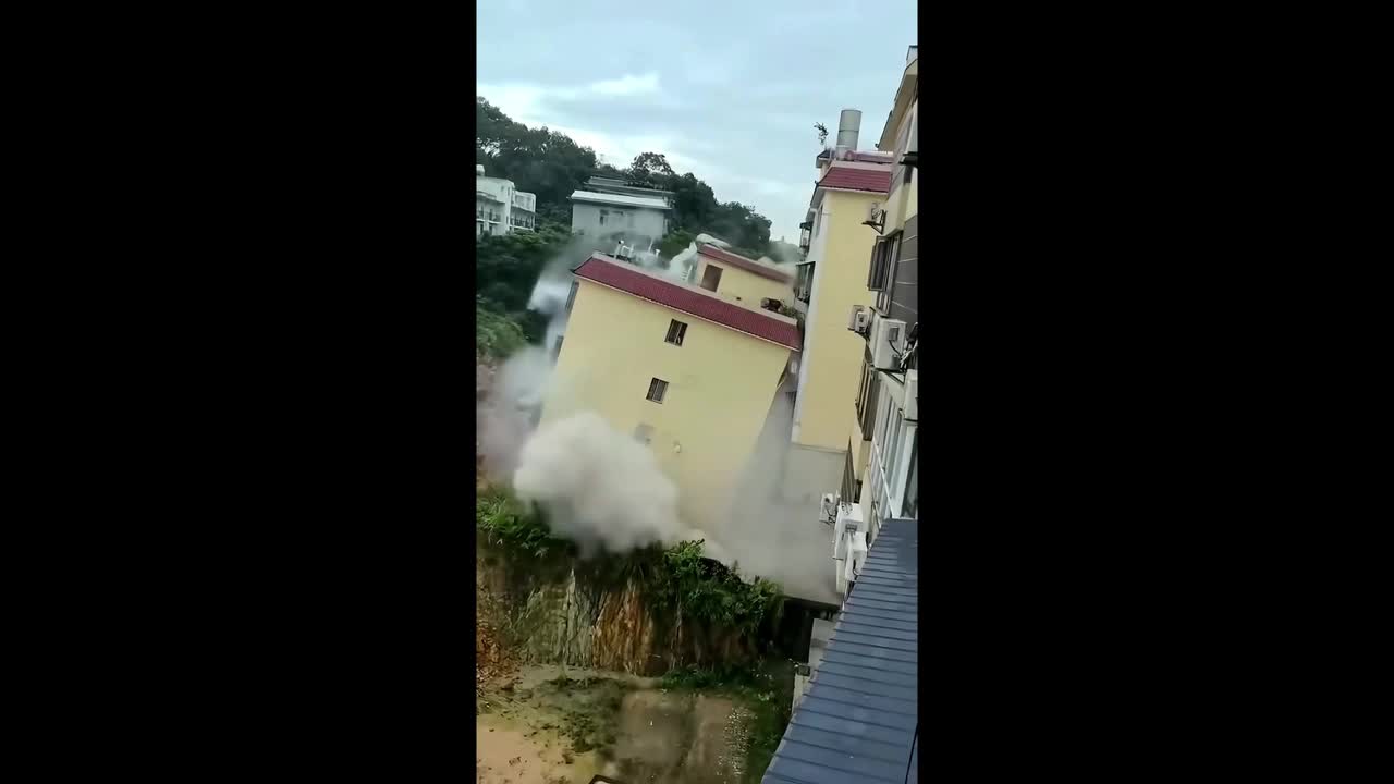 Terrifying moment landslide causes building to slide down hill and ...