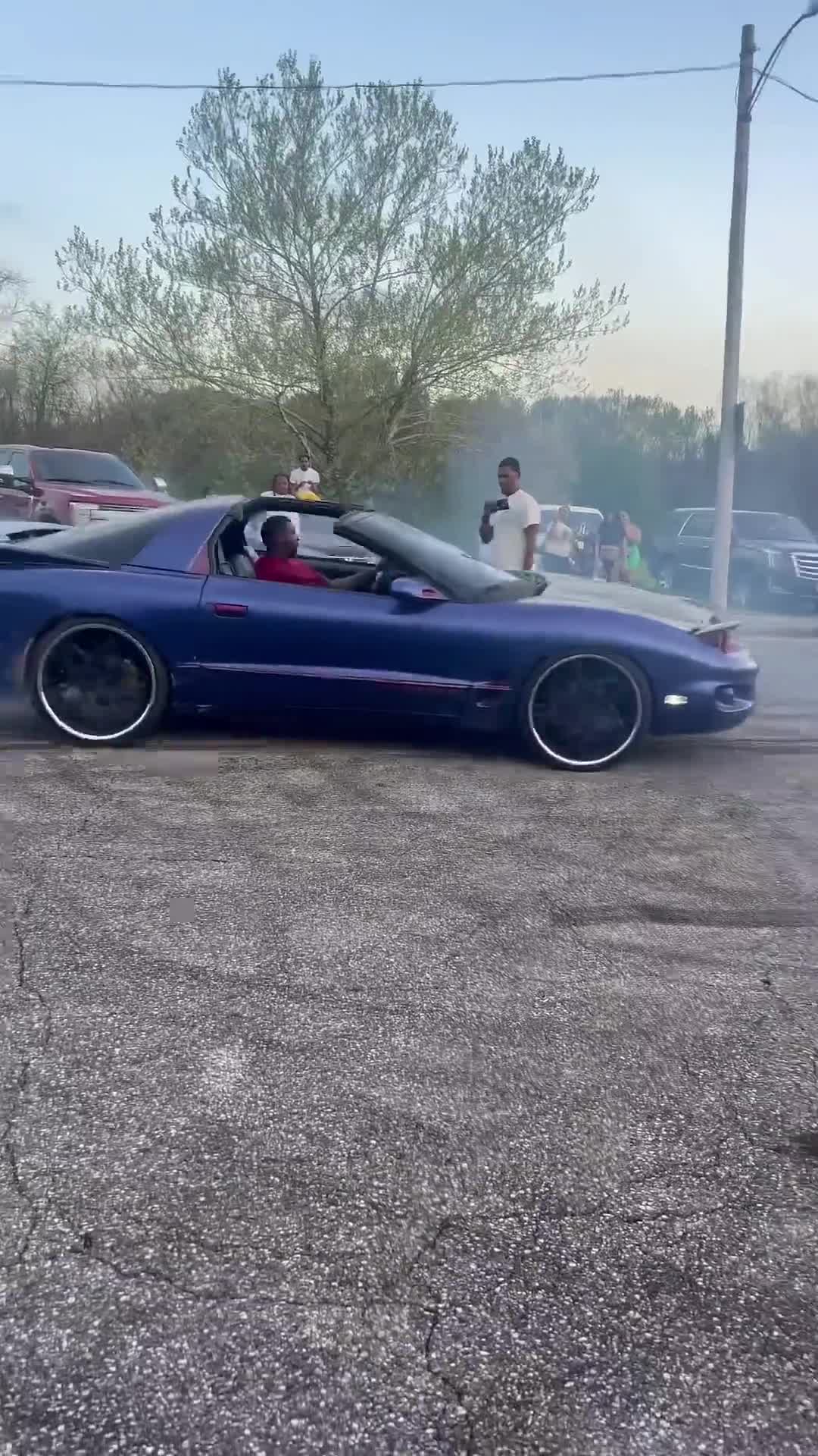 Homie eating donuts in his Pontiac Trans-Am on 22’s