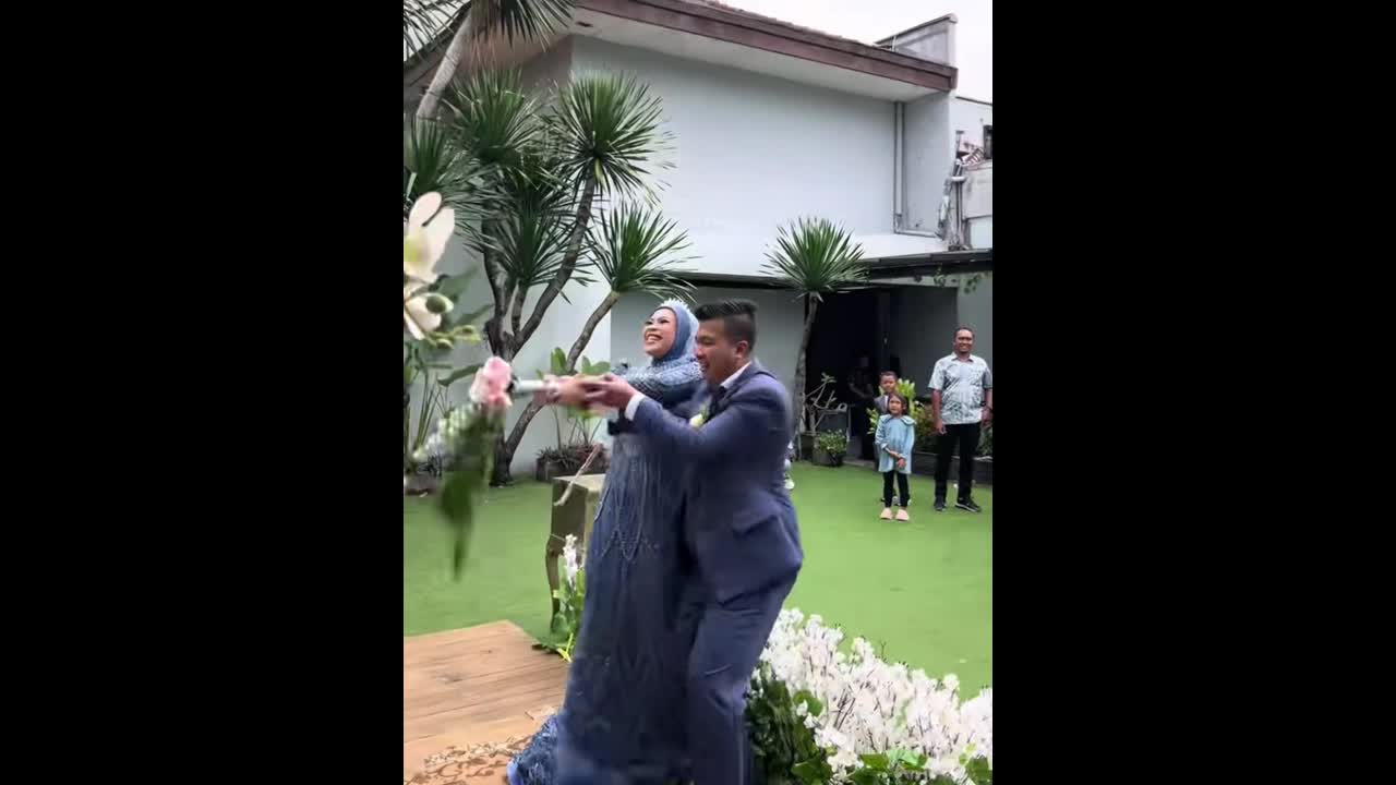 Bride falls after bouquet toss at Bandung wedding in West Java, Indonesia