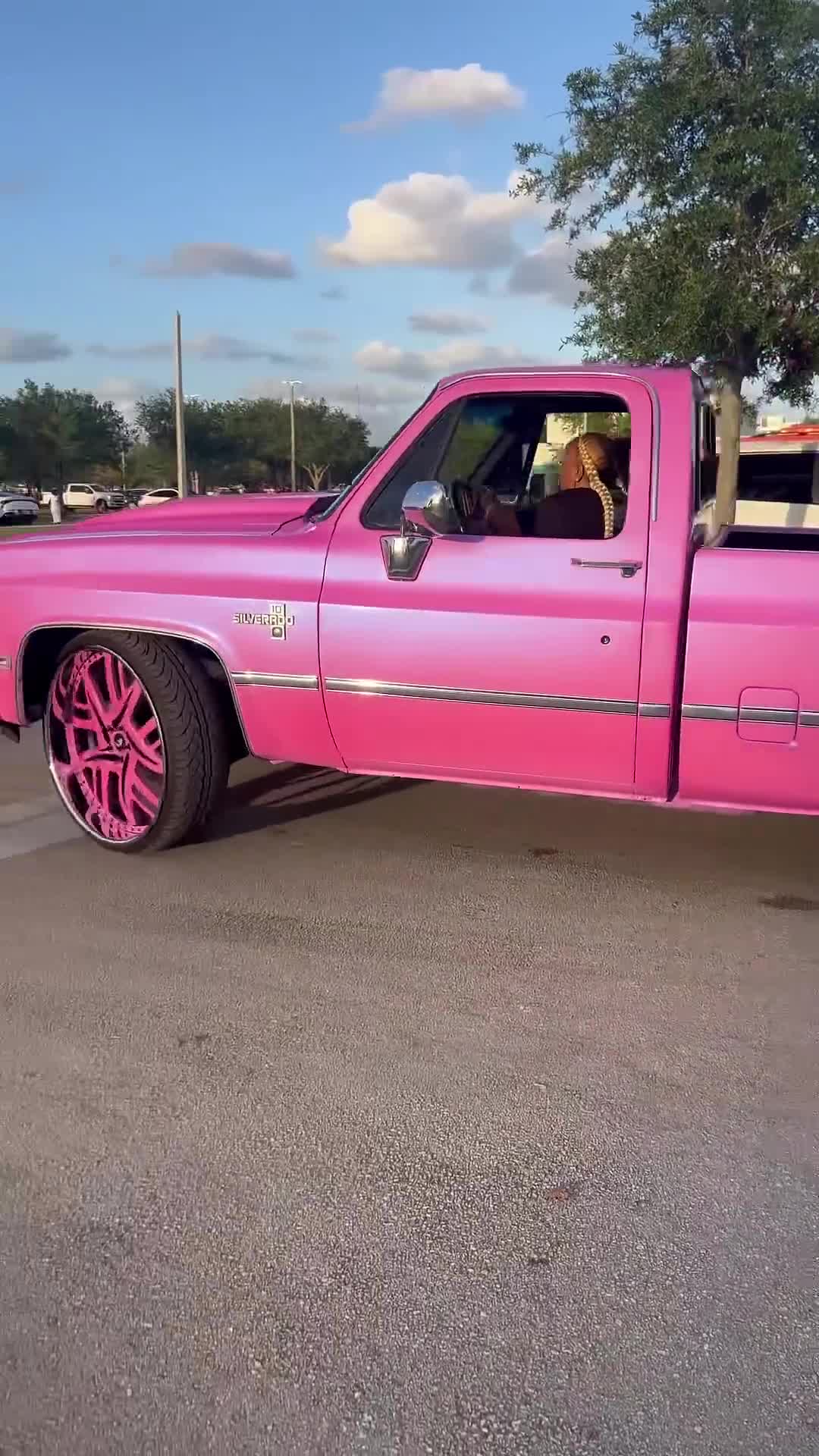 Her outrageous pink Chevy shortbed truck on 28’s Forgiatos