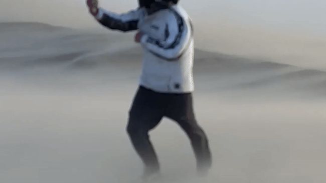 Man Struggles to Stand Amid 93 MPH Winds From Storm Benjamin