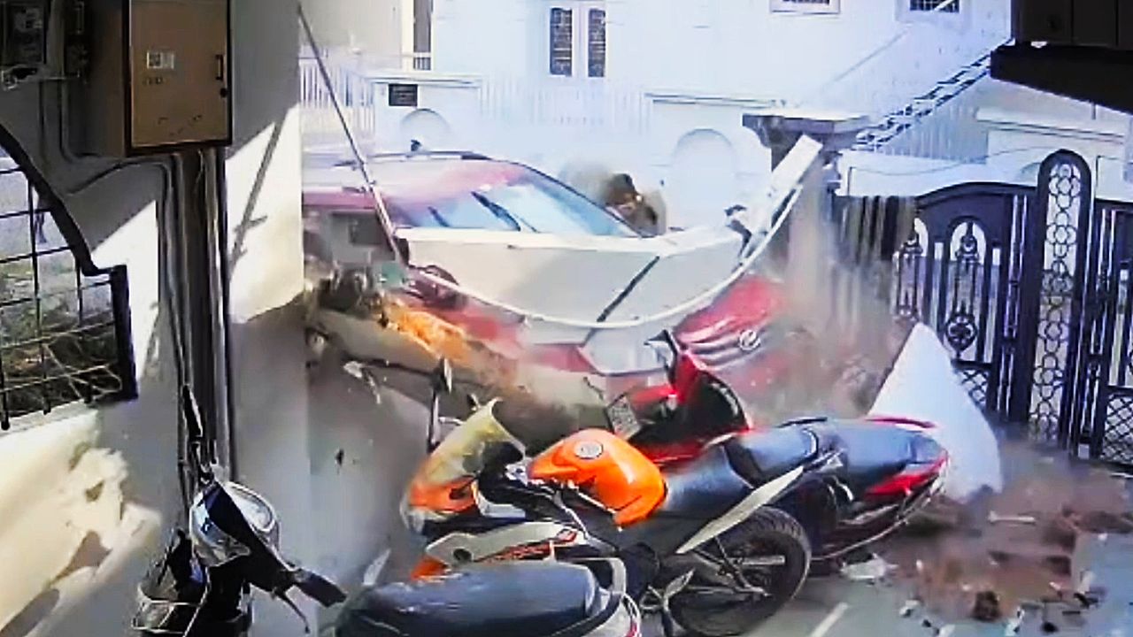 Learner driver crashes through wall after knocking down biker in India