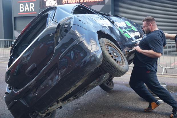 'They made it look easy' - Strongmen flip car outside stadium