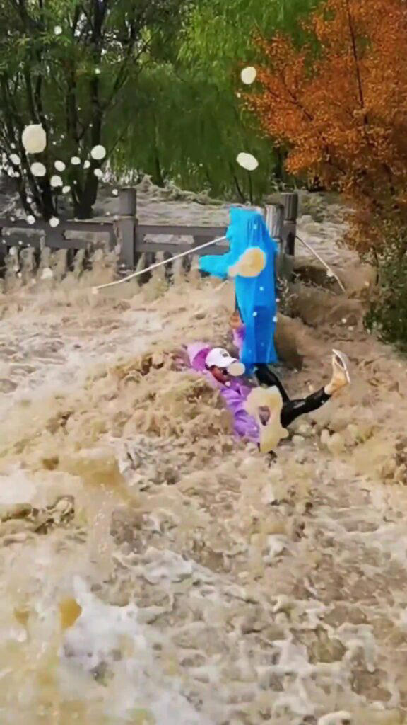 Tourists knocked over as giant tidal wave crashes over riverbank