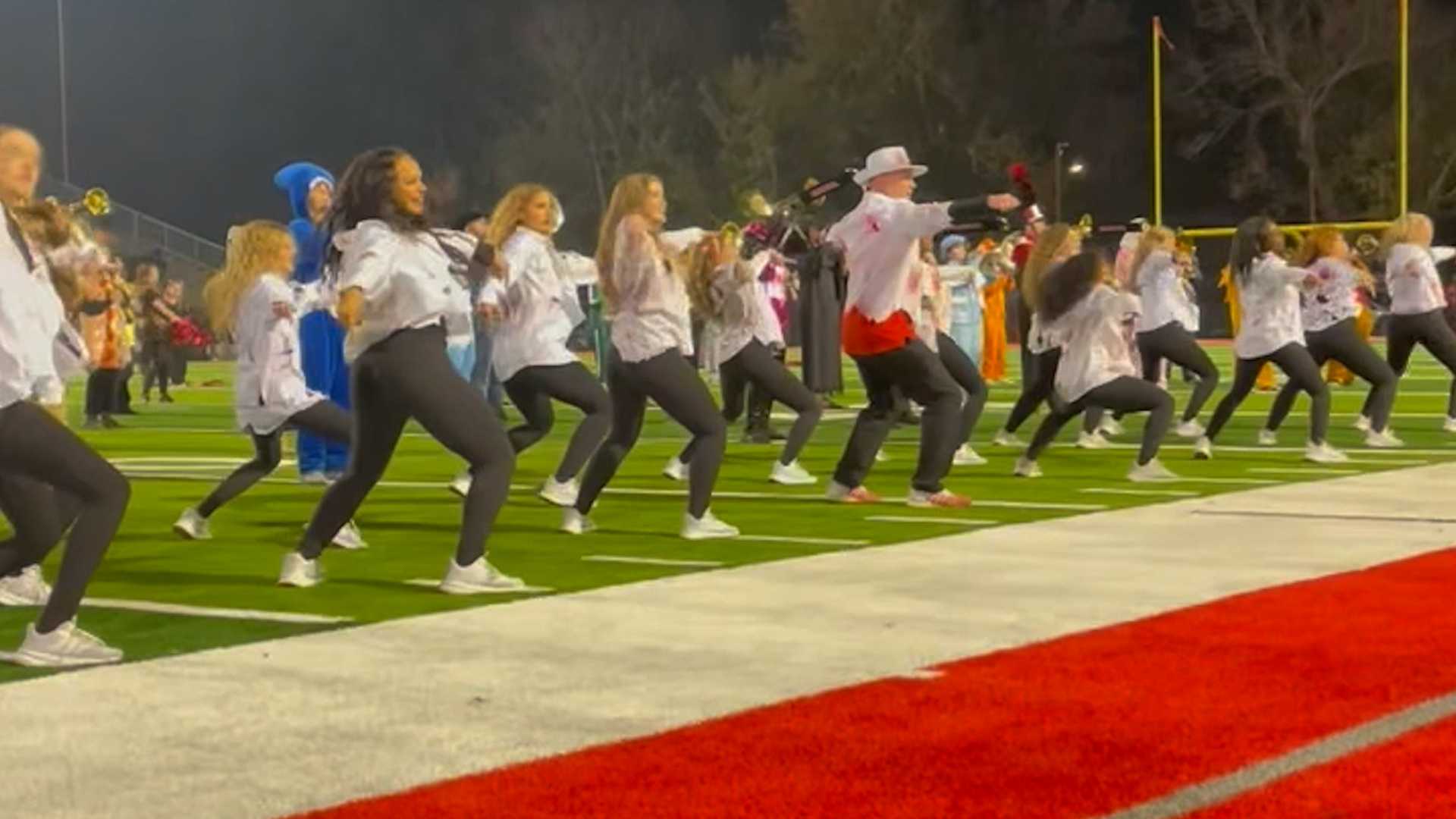 Manual dance team and principal do 'Thriller' dance during halftime of ...