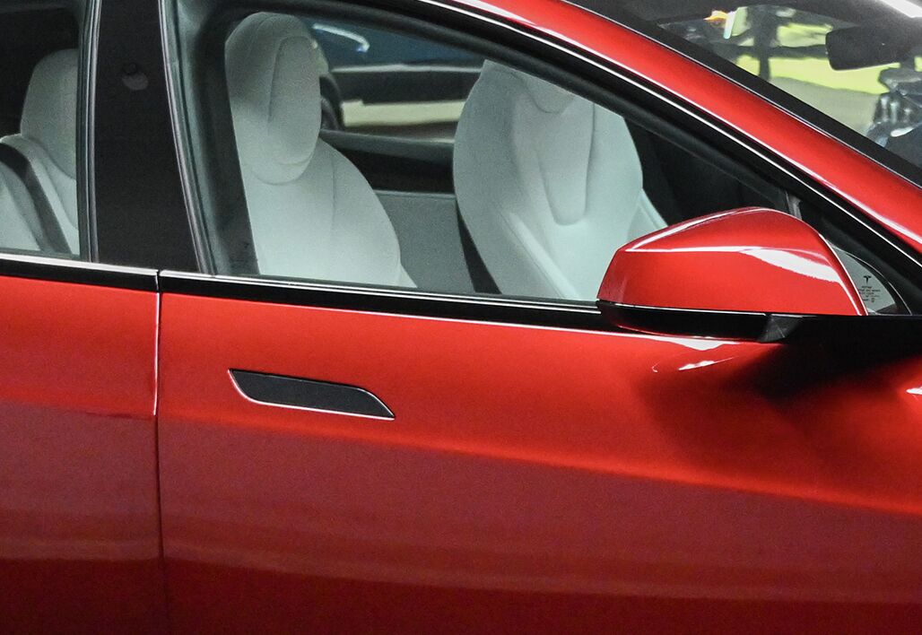 Tesla Sued Over Claim Faulty Doors Led to Deaths in Fiery Crash