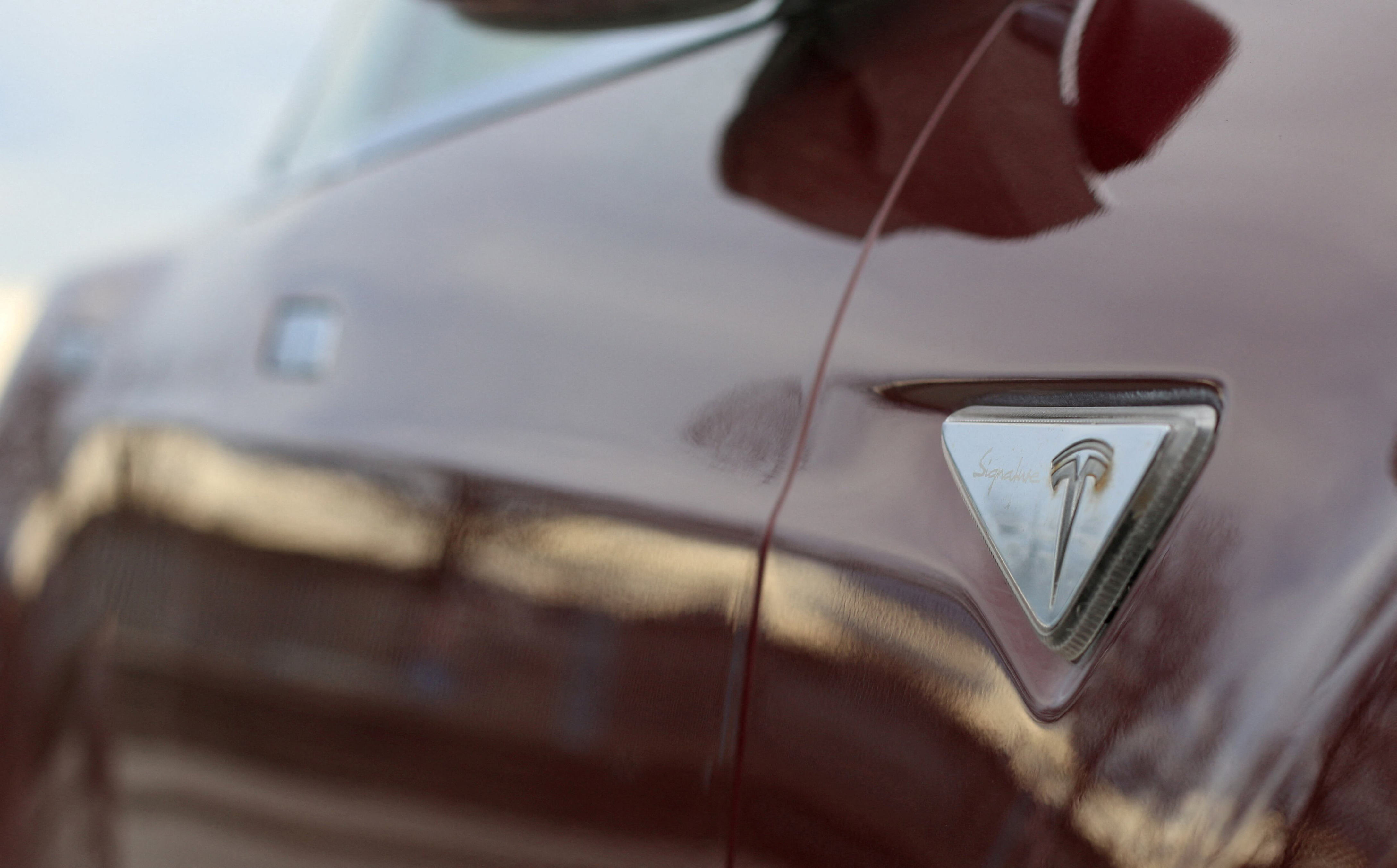 Tesla Sued Over Crash Doors Failure in Fatal Fire