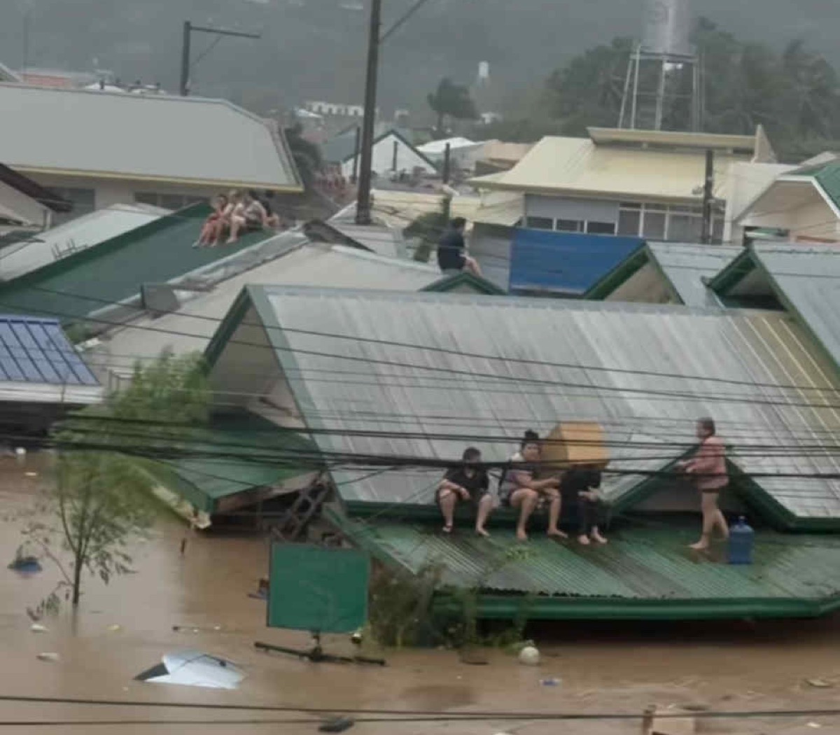 Residents on rooftops plead for rescue as floods swamp Cebu due to Tino