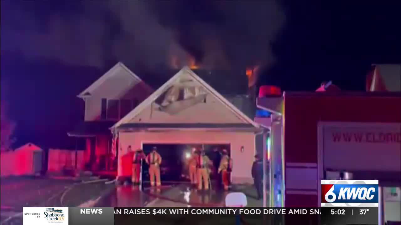 Flames shoot from roof of home as crews battle house fire